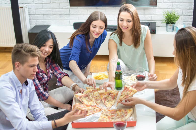 Group of Young People Eating Pizza at Home. Stock Image - Image of hand ...