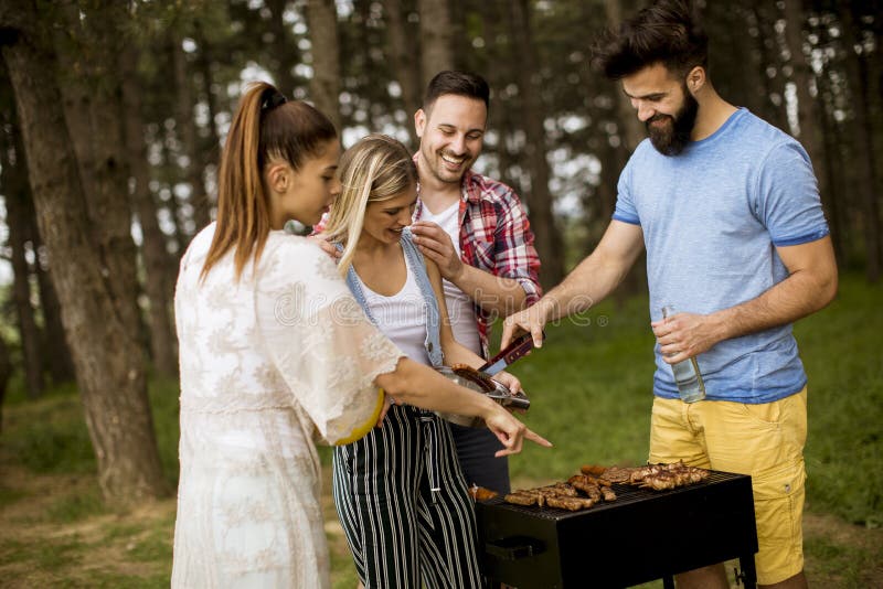 Group of Young People Enjoying Barbecue Party in the Nature Stock Image ...