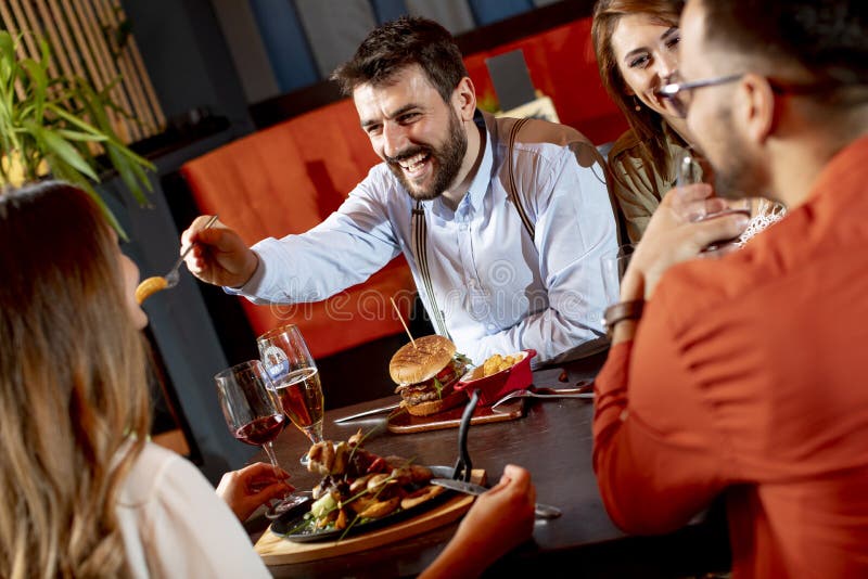 Young People Having Dinner in the Restaurant Stock Image - Image of ...