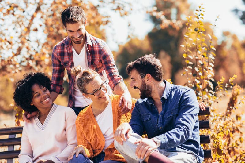 Young People Having Fun Outdoors on Park Bench Stock Photo - Image of ...