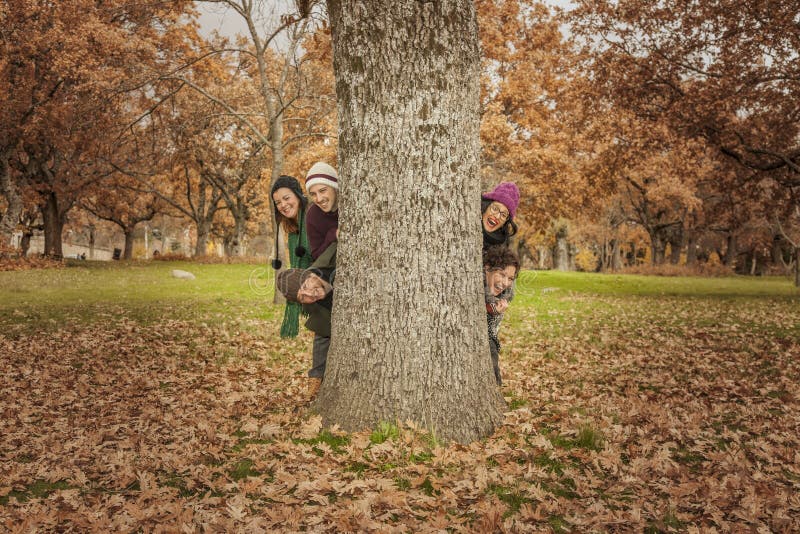 Five Young People Behind a Big Tree. Stock Photo - Image of cold ...