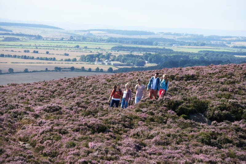 Group of Young People Hiking through Countryside Stock Photo - Image of ...