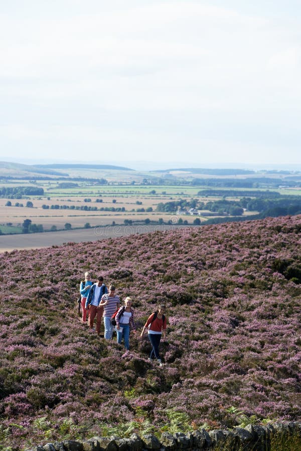 Group of Young People Hiking through Countryside Stock Photo - Image of ...