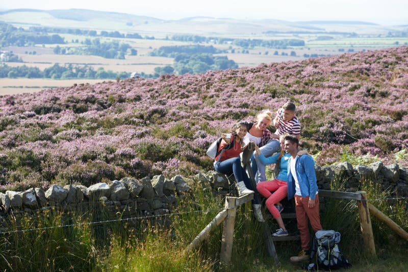 Group of Young People Hiking through Countryside Stock Image - Image of ...