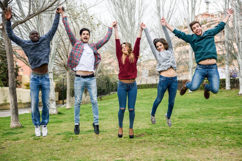 Group of Young People Jumping Together Outdoors Stock Photo - Image of ...