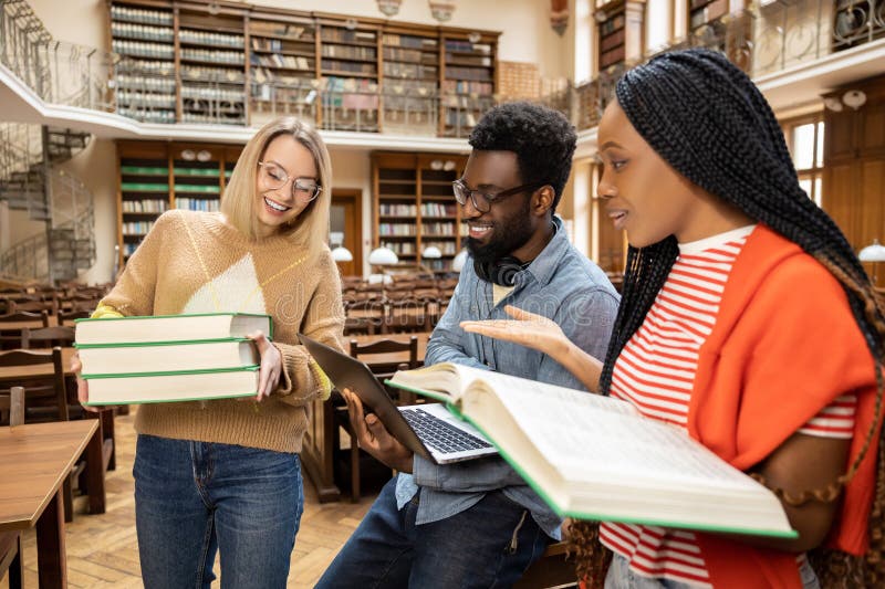 Group of Young People in the Library Looking Busy and Involved Stock ...