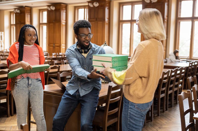 Group of Young People in the Library Looking Busy and Involved Stock ...