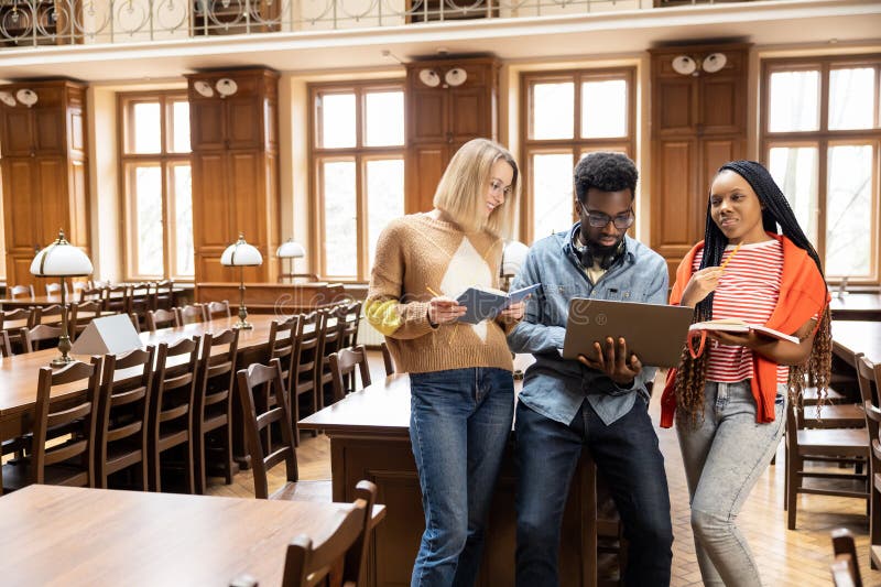Group of Young People in the Library Looking Busy and Involved Stock ...
