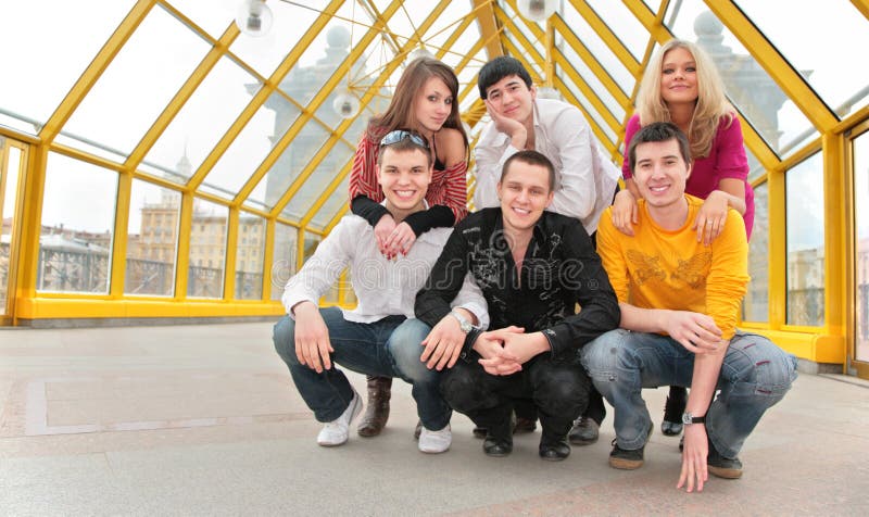 Group of young people pose stock image. Image of inside - 4964443