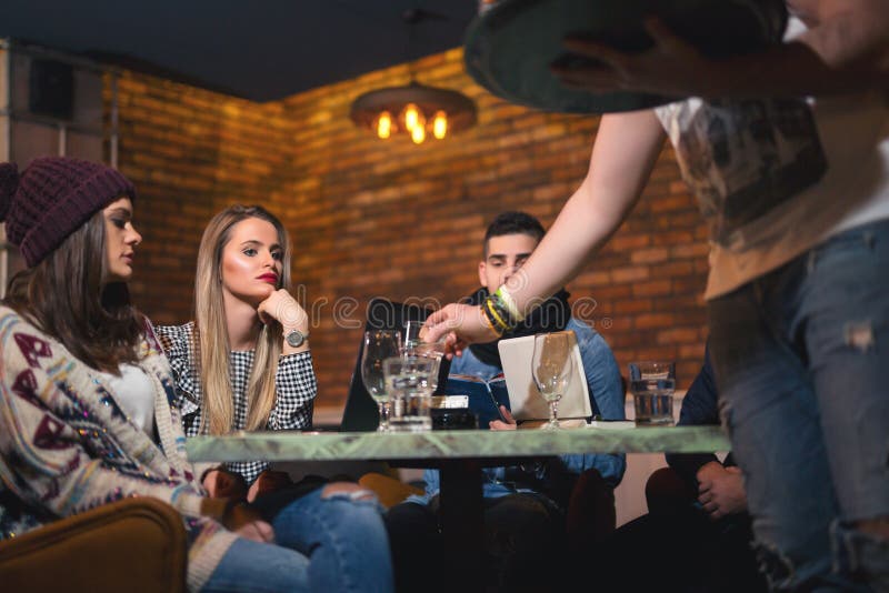 Group of Young People Sitting in a Coffee Shop Having Fun Stock Photo ...