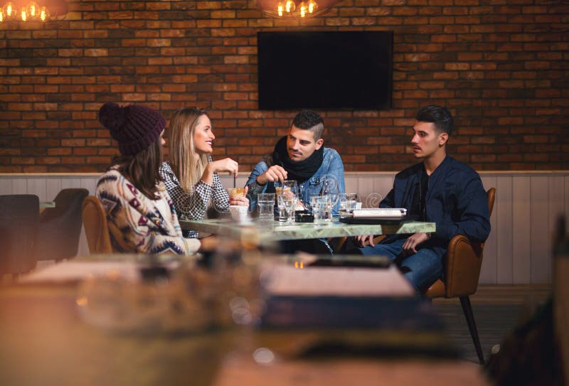 Group of Young People Sitting in a Coffee Shop Stock Photo - Image of ...