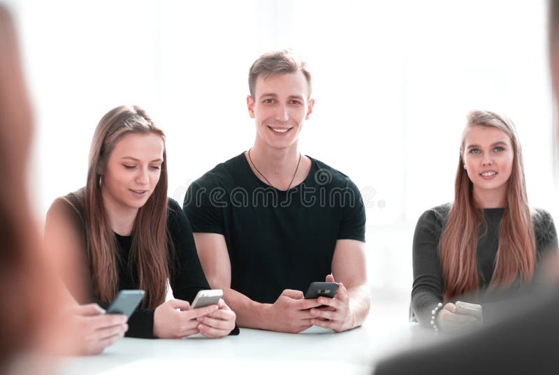 Group of Young People Sitting at a Round Table Stock Image - Image of ...