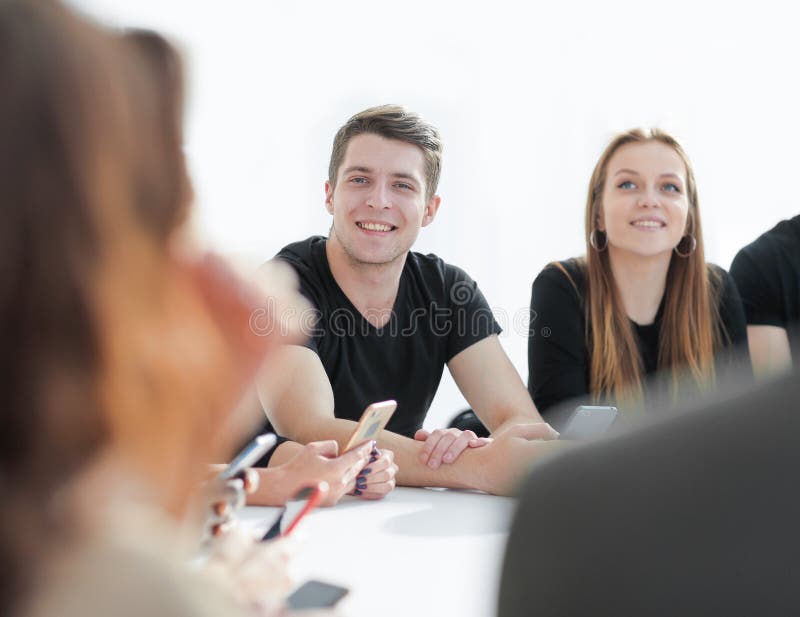 Group of Young People Sitting at a Round Table Stock Image - Image of ...