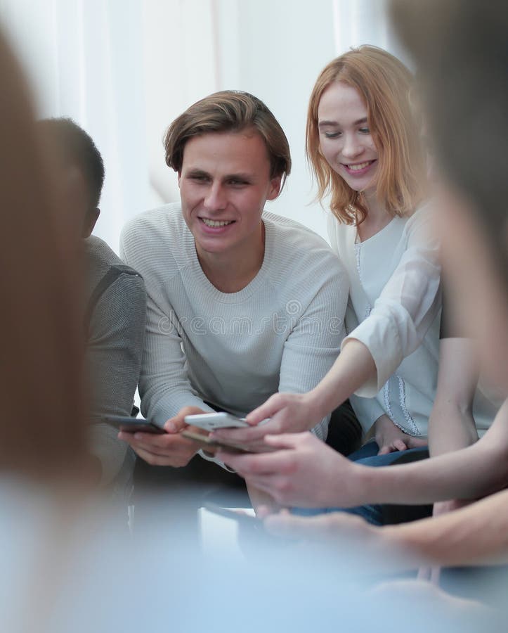 Group of Young People with Smartphones Sitting at a Table. Stock Photo ...