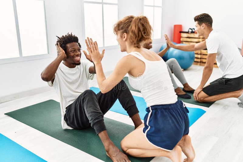 Group of Young People Smiling Happy Training Abdominal Exercise at ...