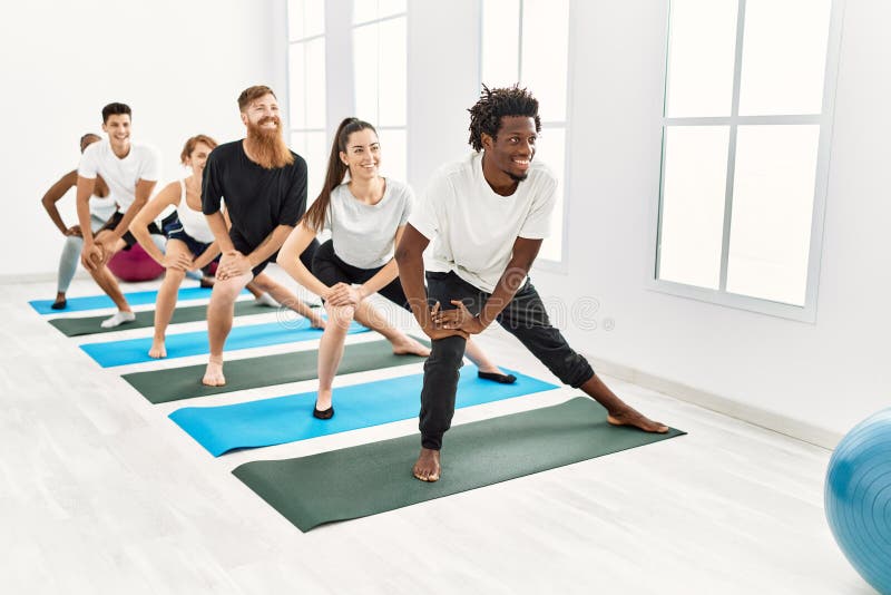 Group of Young People Smiling Happy Training Legs Exercise at Sport ...