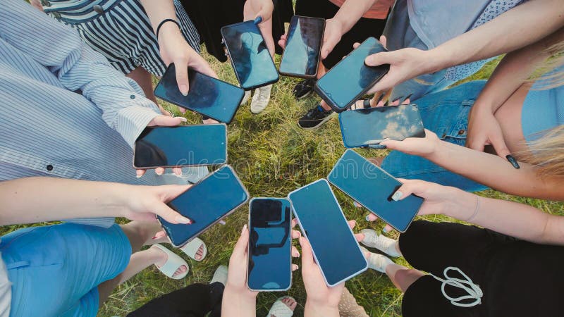 Group of Young People Standing in a Circle on the Grass Showing Their ...