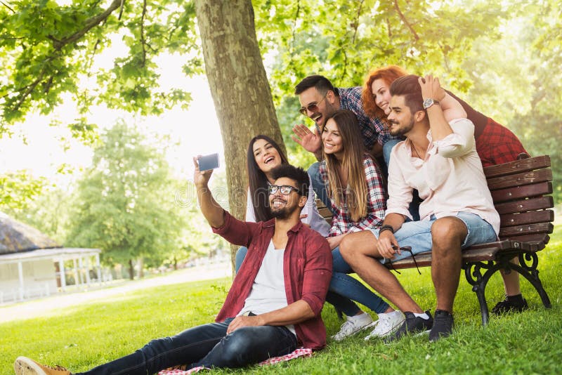 Group of Young People Taking a Selfie Outdoors on the Bench, Having Fun ...
