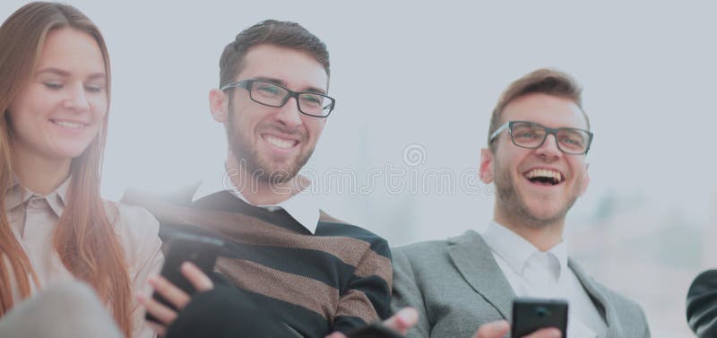 A Group of Young and Happy Young People Using Their Phones and C Stock ...