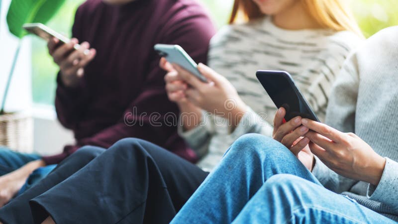 Group of Young People Using and Looking at Mobile Phone Together Stock ...