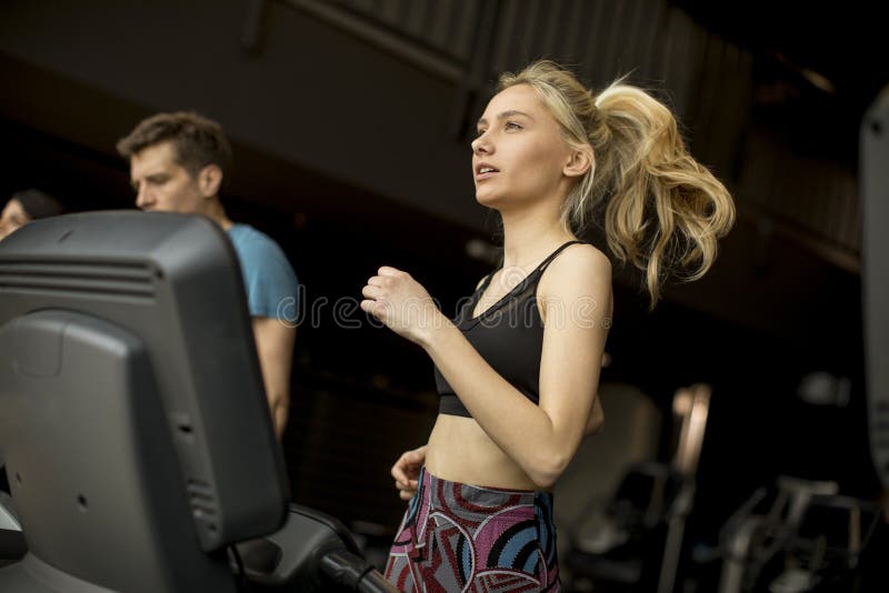 Young People Using Threadmill in Modern Gym Stock Photo - Image of ...