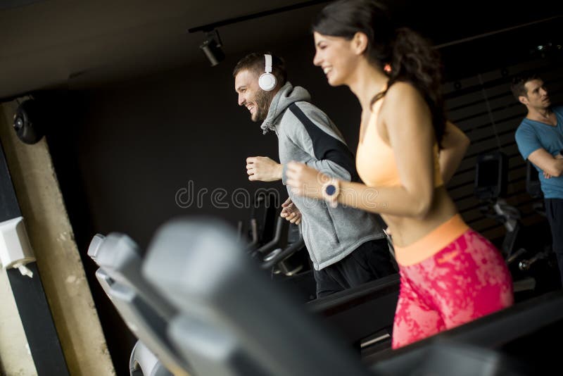 Young People Using Threadmill in Modern Gym Stock Photo - Image of ...