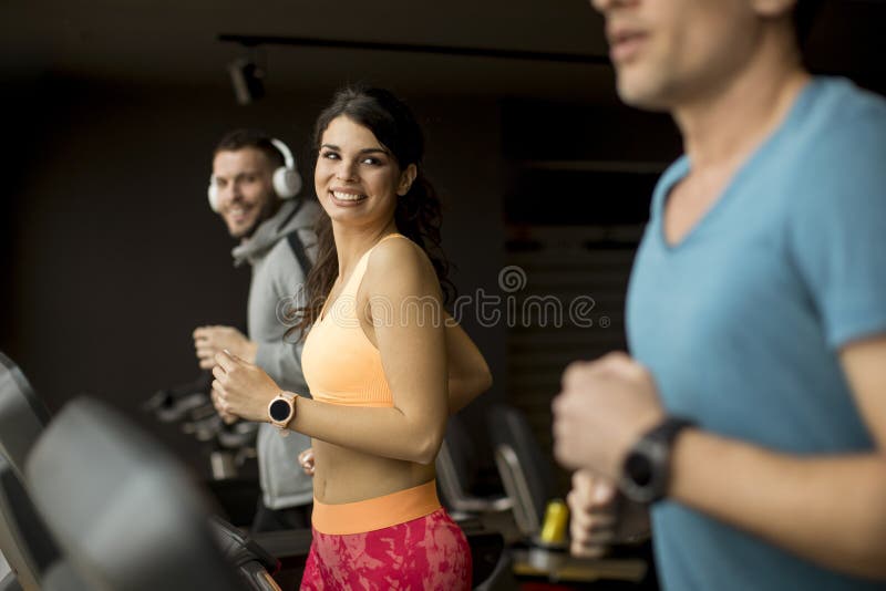 Young People Using Threadmill in Modern Gym Stock Image - Image of ...