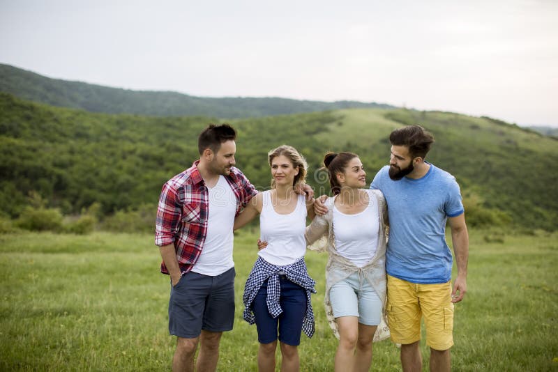 Group of Young People Walking in the Summer Field Stock Image - Image ...