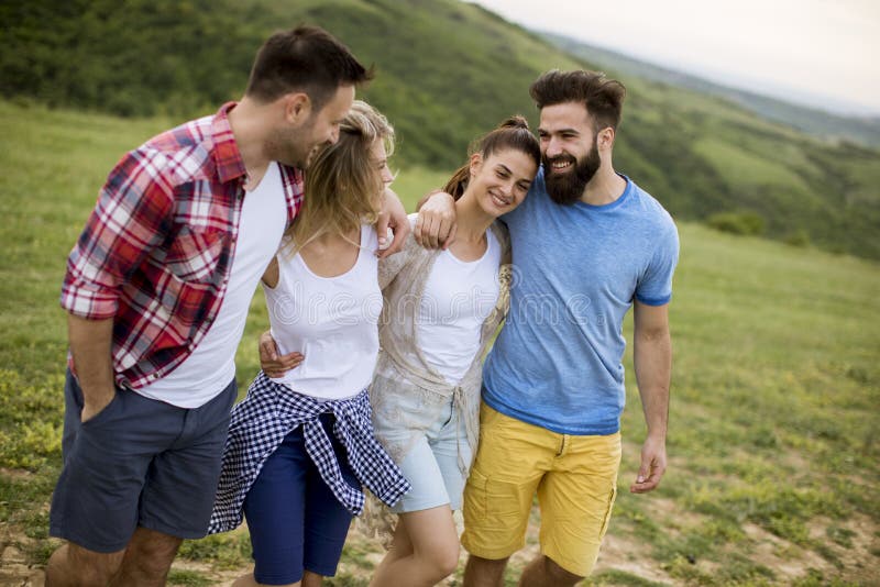 Group of Young People Walking in the Summer Field Stock Image - Image ...