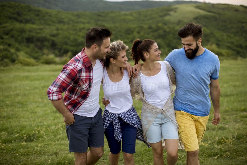Group of Young People Walking in the Summer Field Stock Photo - Image ...