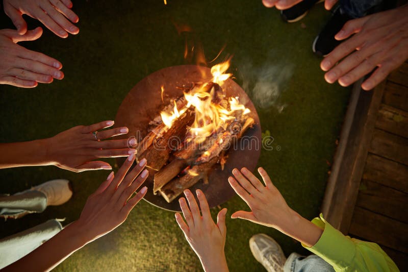 Group of Young People Warming Hands Over Burning Campfire Closeup Stock ...