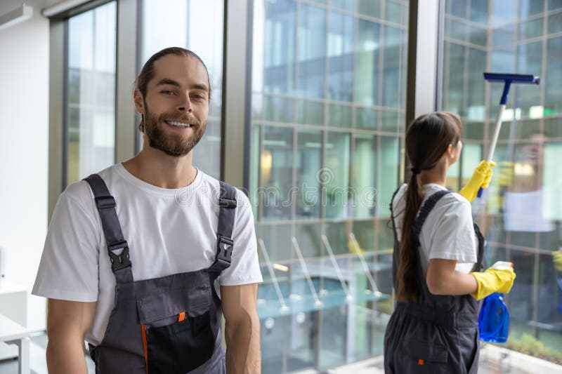 Group of Young People Working on Cleaning the Office and Looking Busy ...