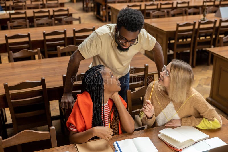 Group of Young People Working Together and Looking Involved Stock Photo ...