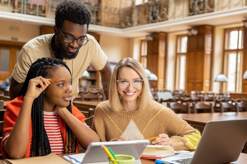 Group of Young People Working Together and Looking Involved Stock Photo ...