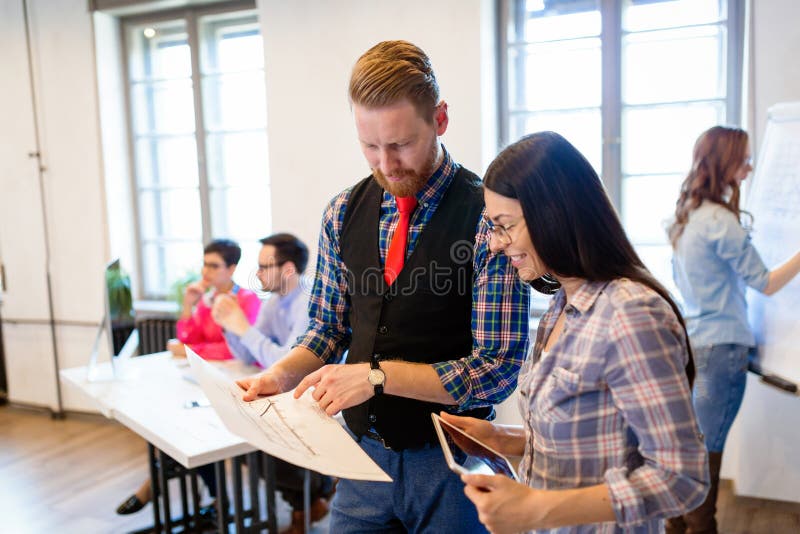 Group of Young Perspective Architects Looking at Project Papers Stock ...
