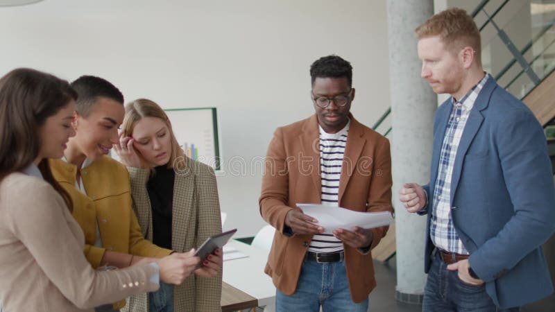Group of Young Positive Businesspeople Standing Together in the Office ...