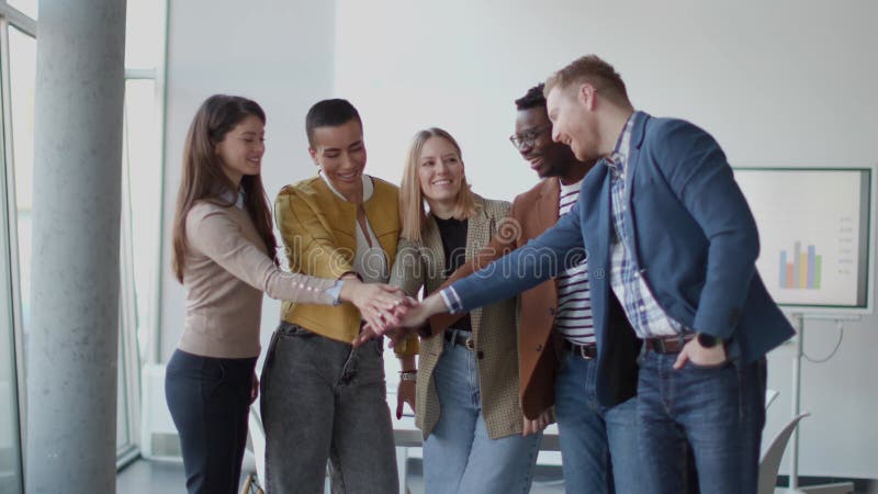 Group of Young Positive Businesspeople Standing Together in the Office ...