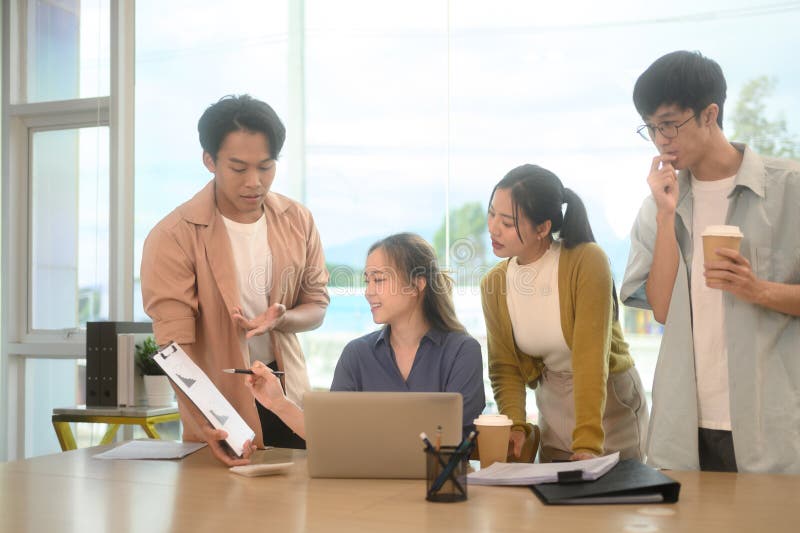 Group of Young Professional Businesspeople Sharing Ideas and Review ...