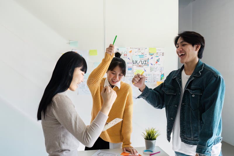 Creative Team Collaborating on UX UI Design Project in Modern Office ...