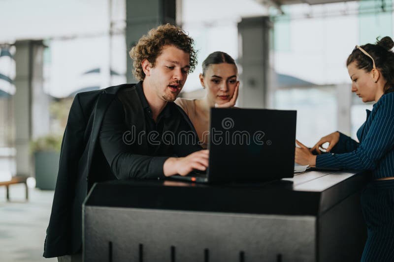 Group of Young Professionals Working Together on a Laptop in a Modern ...