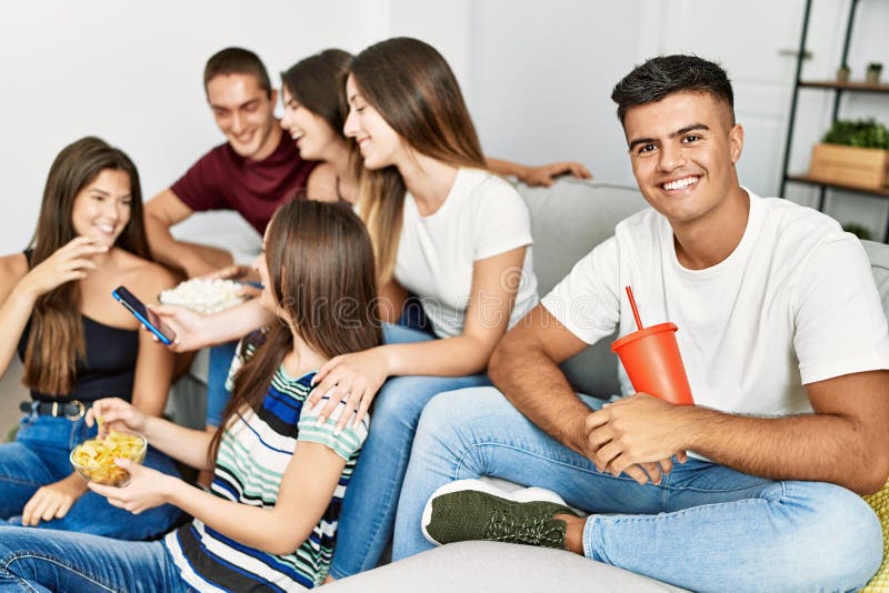 Group of Young Smiling Happy Sitting on the Sofa Eating at Home Stock ...