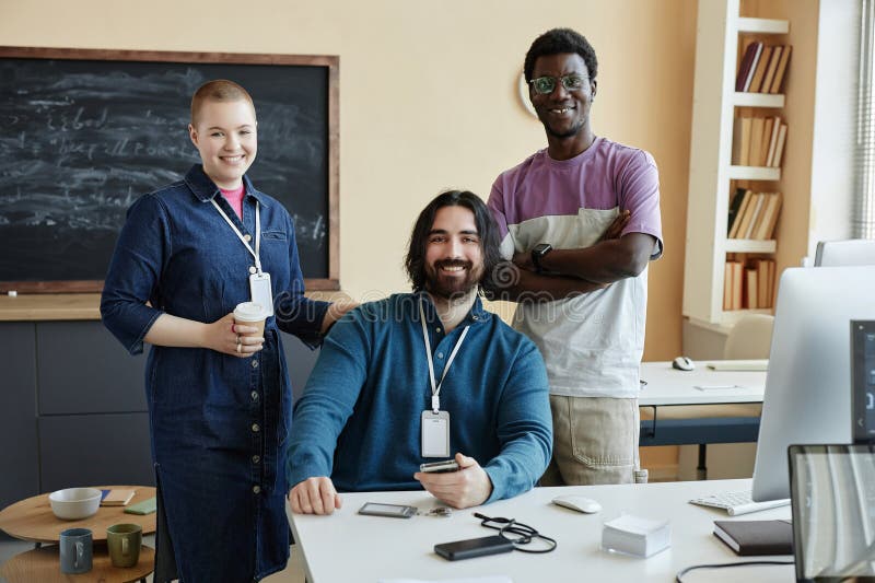 Group of Young Smiling Intercultural Office Managers Looking at Camera ...