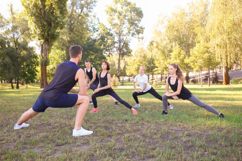 Group of Young Sporty People Doing Exercise Outdoors Stock Image ...