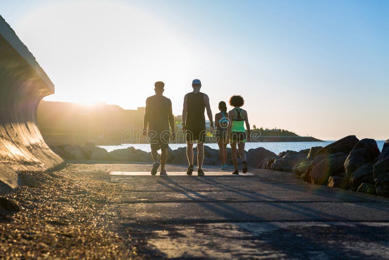 Group of Young Sporty People Doing Exercise Together Stock Photo ...