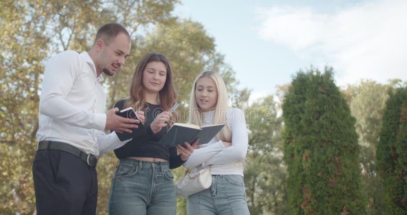 Group of Young Students, Potentially Students, Engaged in a Lively ...