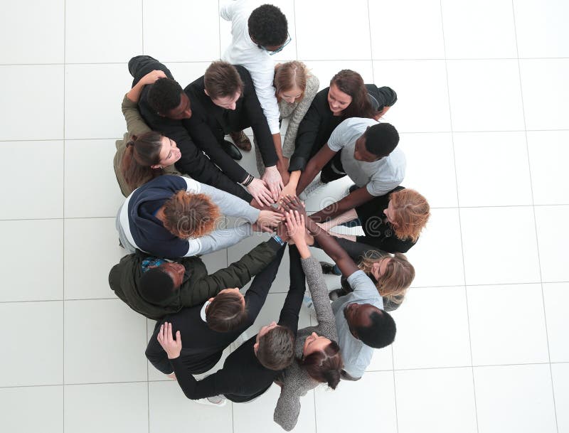 Group of Young Successful People Stands Around Hands Together Stock ...