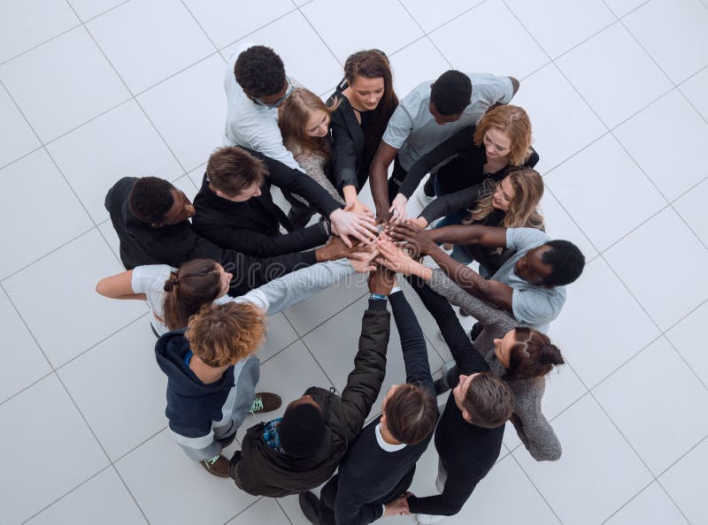 Group of Young Successful People Stands Around Hands Together Stock ...