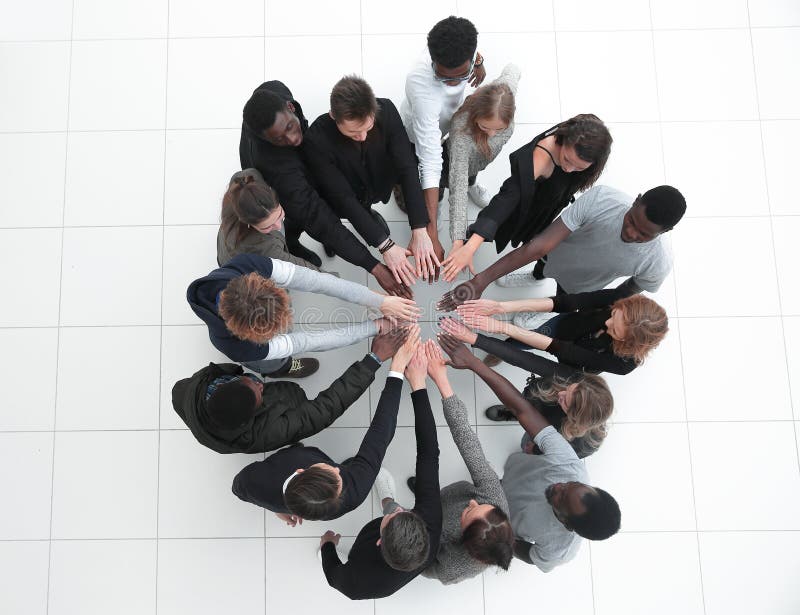 Group of Young Successful People Stands Around Hands Together Stock ...