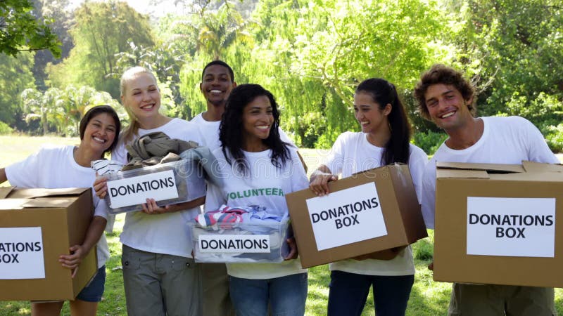 Group of Young Volunteers Holding Donation Boxes Stock Video - Video of ...