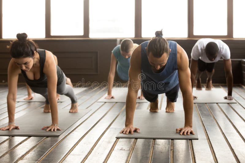 Group of Young People Standing in Plank Pose Stock Image - Image of ...